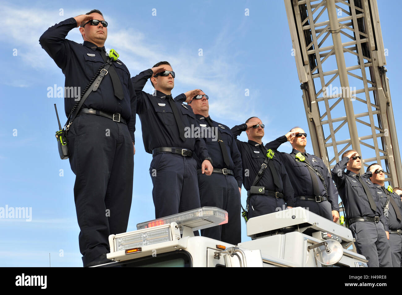 Police, firemen and civilians gather on a highway overpass to show ...