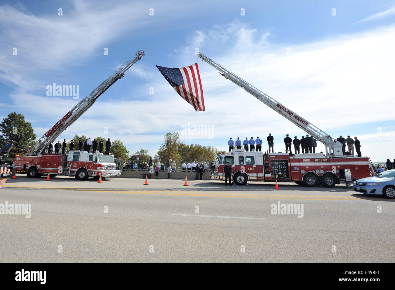 Police, firemen and civilians gather on a highway overpass to show ...