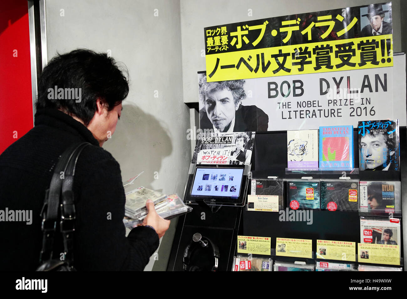 A man looks at Bob Dylan's music on display at Tower Records Shibuya on ...