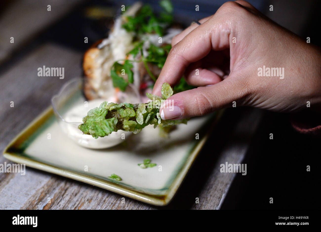 A woman holds Spree forest cucumber sticks in a crispy cover made of ...
