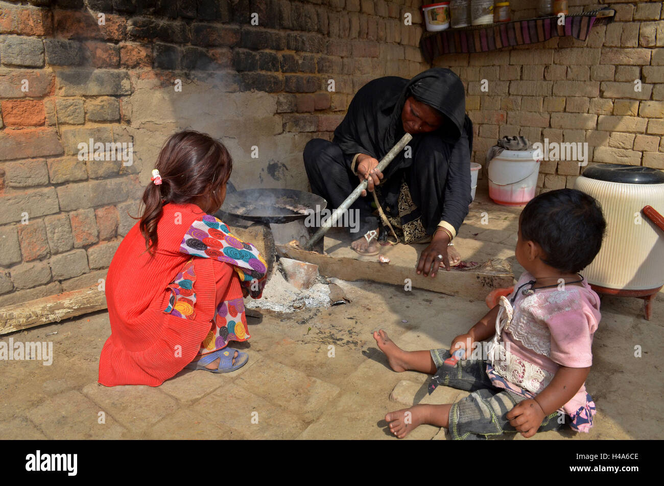 Lahore. 15th Oct, 2016. A Pakistani rural woman (C) cooks in eastern ...