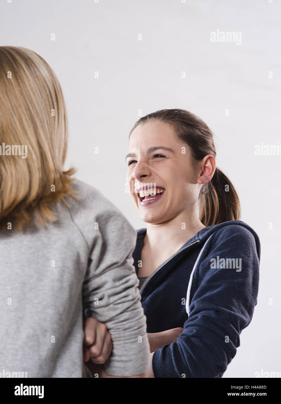 Teenage girl, eye contact, laughing, having fun, studio Stock Photo - Alamy