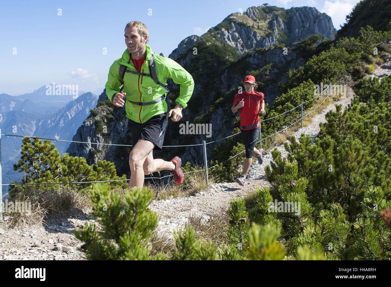 Two young mountain runners on mountain path Stock Photo - Alamy