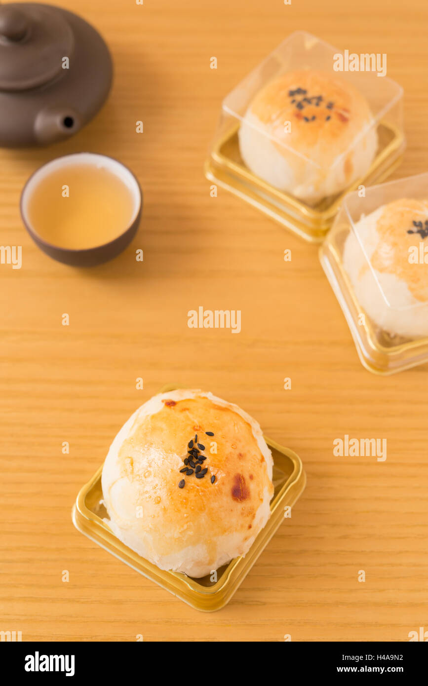 traditional chinese snack of preserved egg cakes with tea on a wood ...