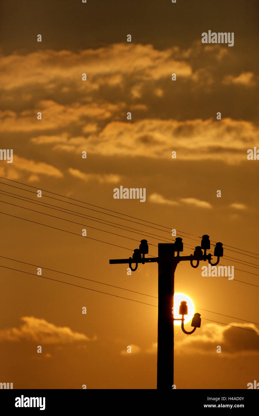 The sun seems behind telegraph mast Stock Photo - Alamy