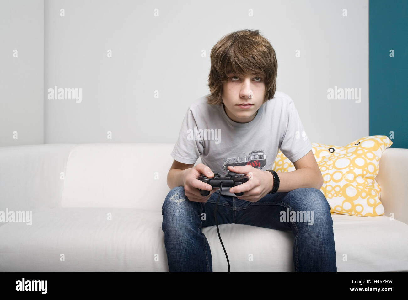Teenager, boy, sofa, computer game Stock Photo - Alamy