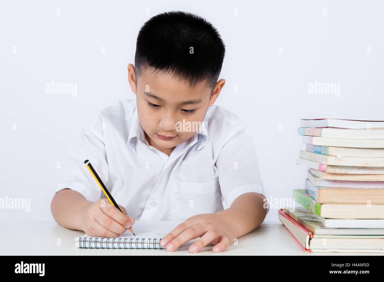 Asian Chinese Little Boy Wearing Student Uniform Writting Homework in ...