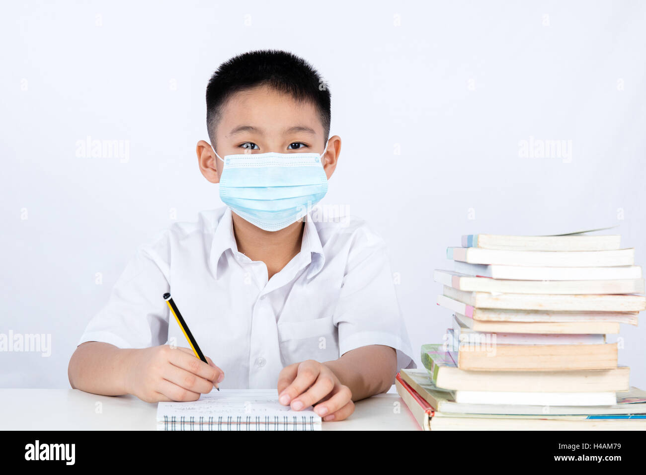Asian Chinese Student Boy Writing with Protection Mask Stock Photo - Alamy