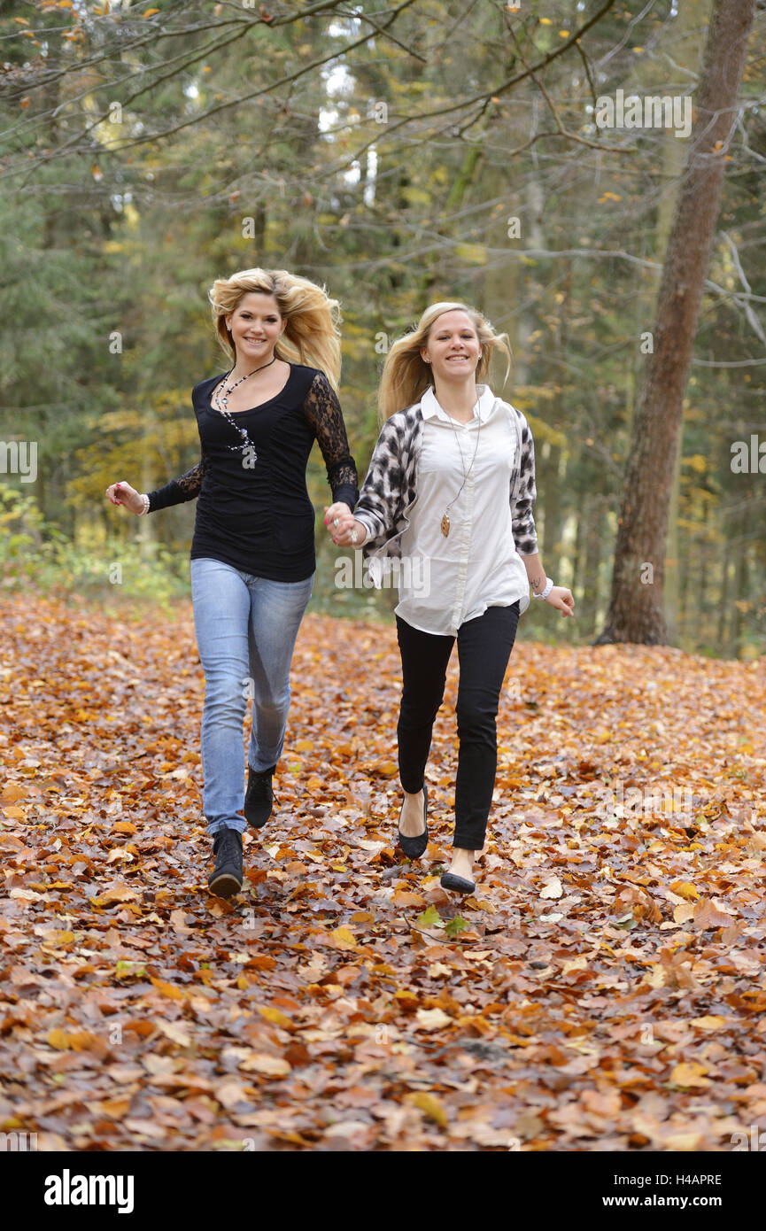 Young women, running, looking at camera Stock Photo - Alamy