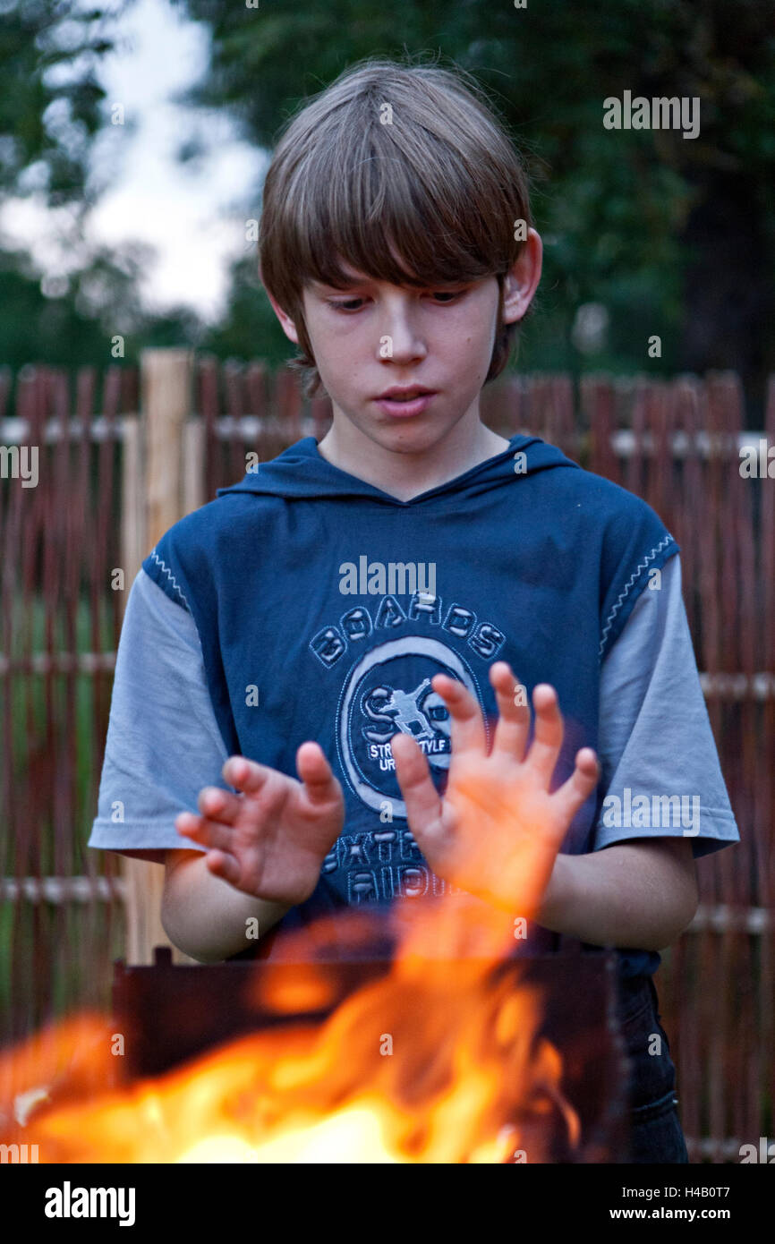 A boy standing at the campfire Stock Photo - Alamy