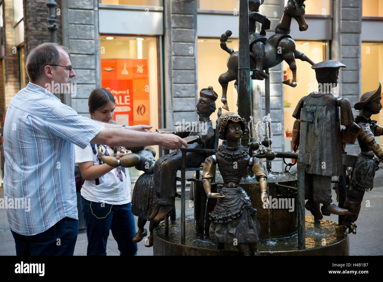 Water fountain with brass moveable childrens puppets in Aachen Germany ...