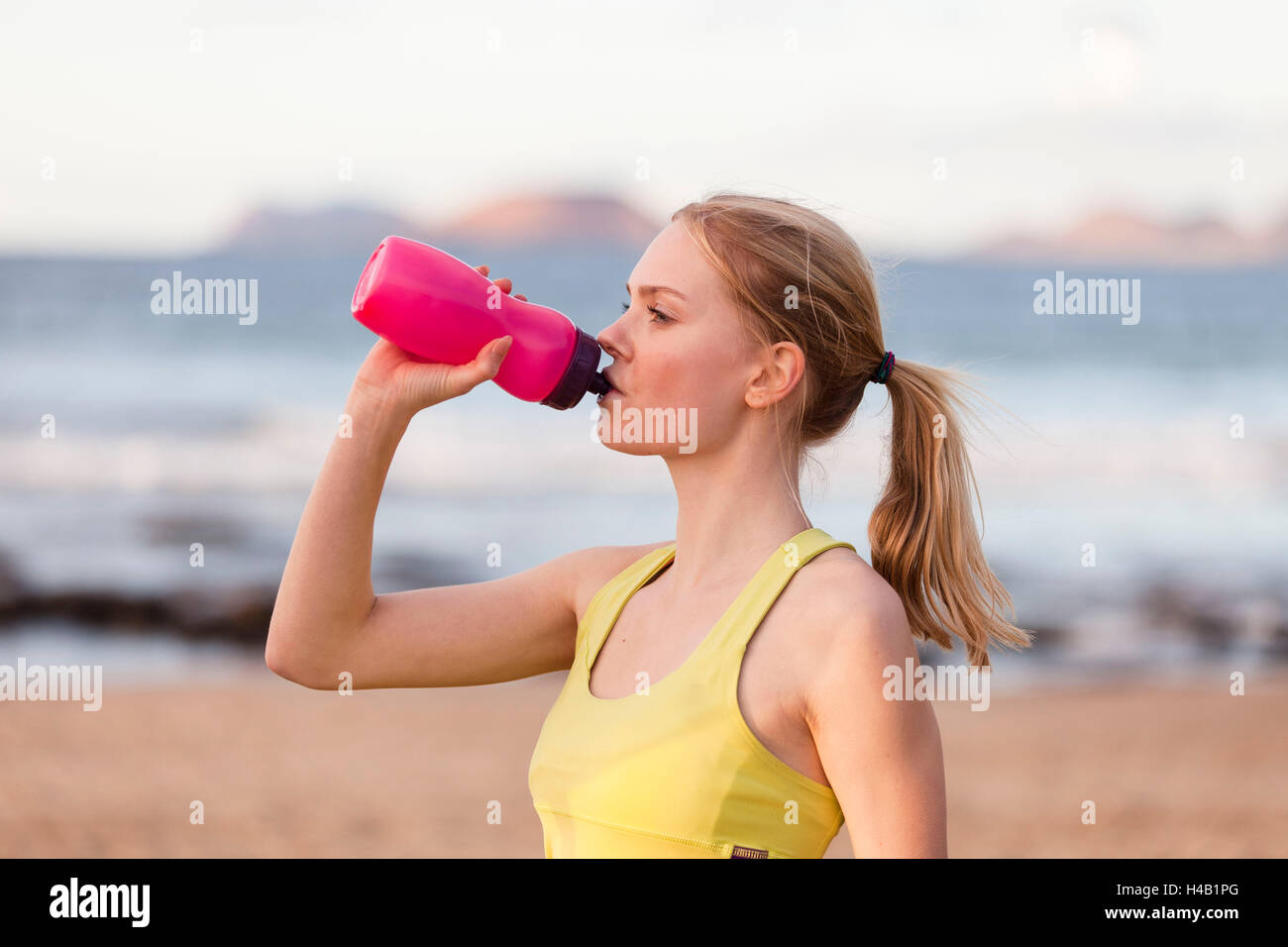 young woman drinking after jogging Stock Photo - Alamy