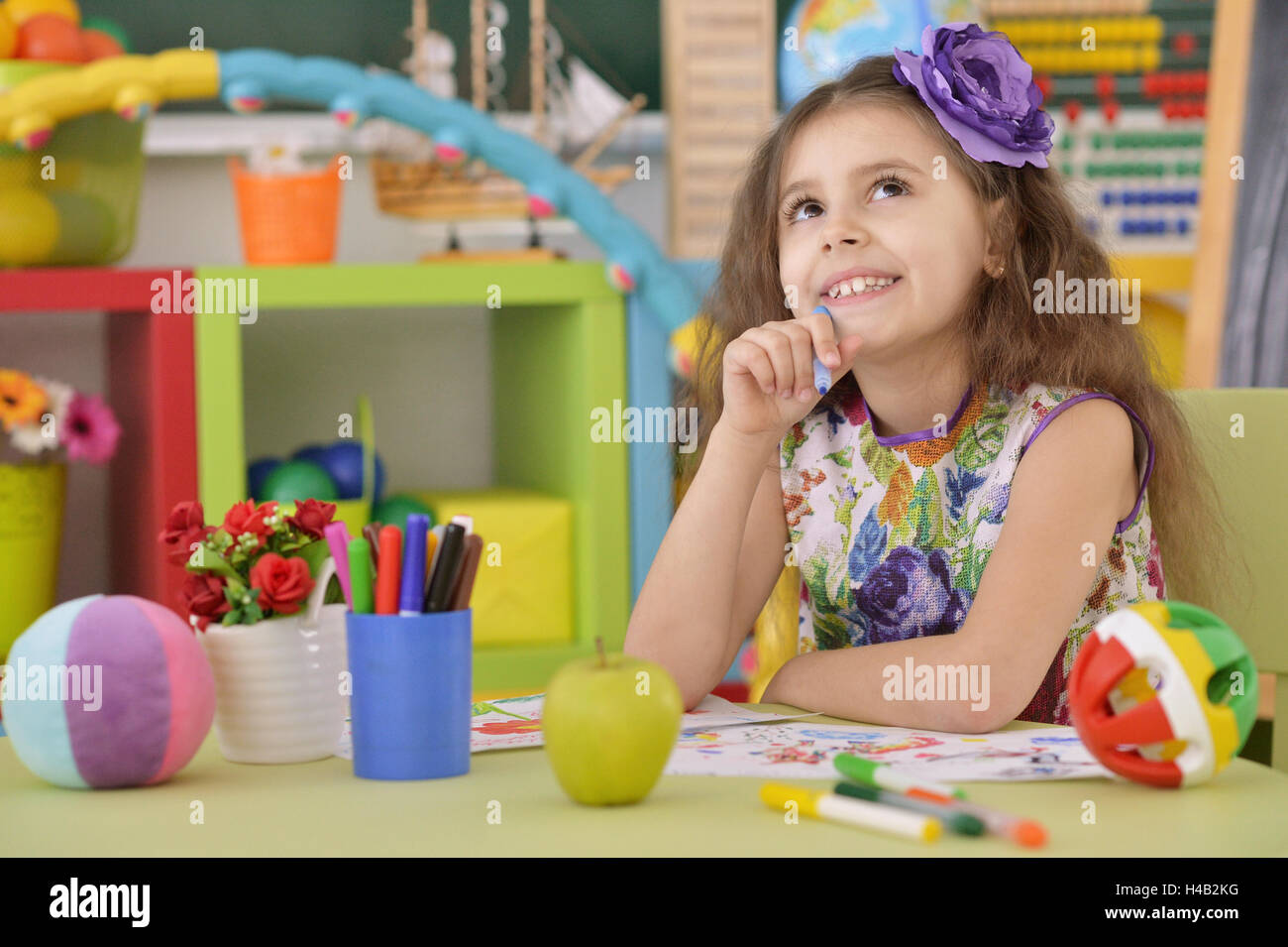 Little girl drawing at class Stock Photo - Alamy