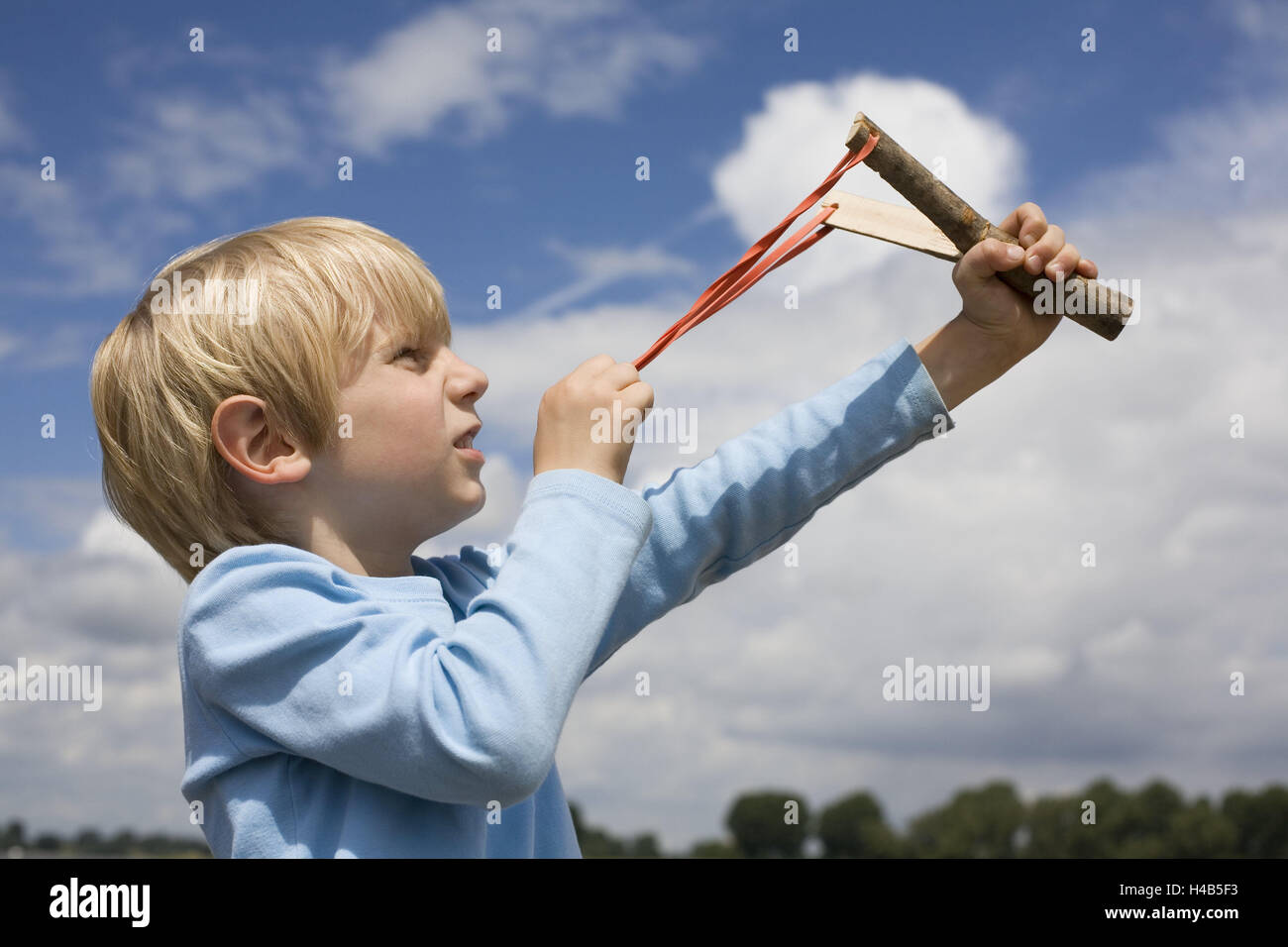 Boy, catapult, aim, steer side view, half portrait Stock Photo - Alamy