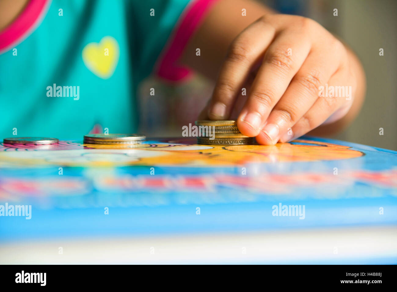 Baby girl making stack of Indian coins, Pune, Maharashtra, India Stock ...