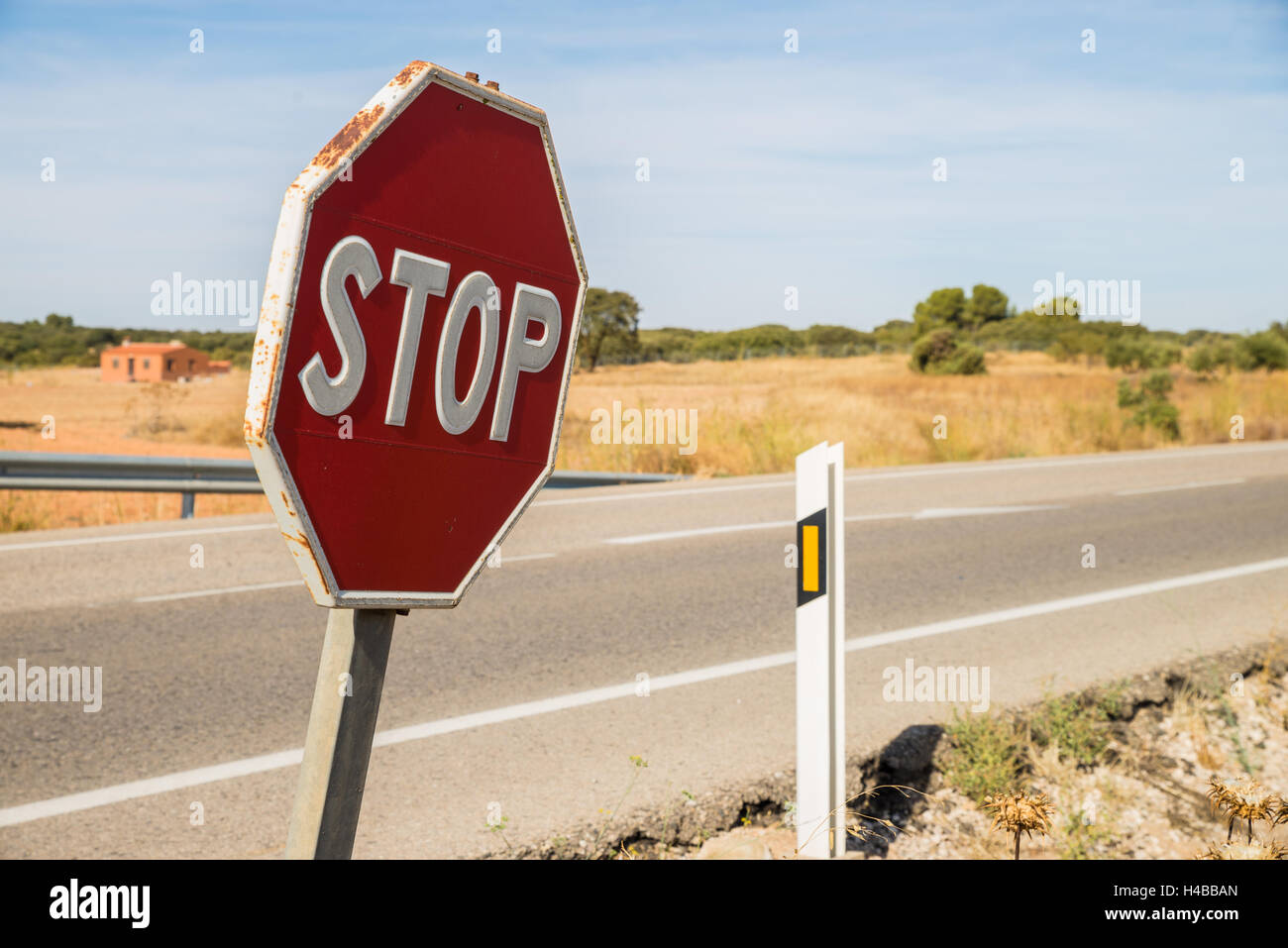 Old stop sign on a paved road Stock Photo - Alamy