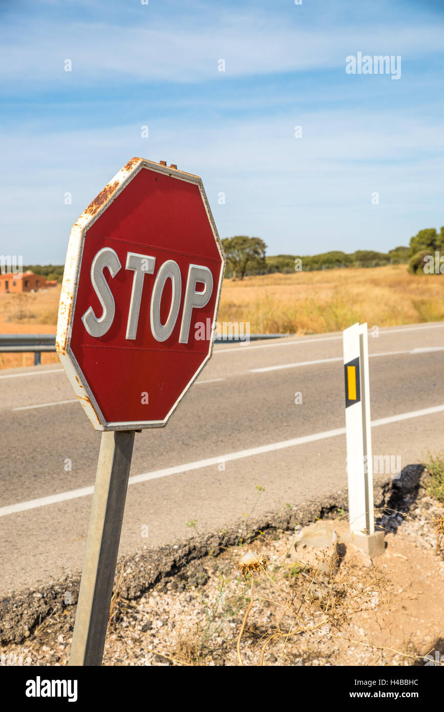 Old stop sign on a paved road Stock Photo - Alamy
