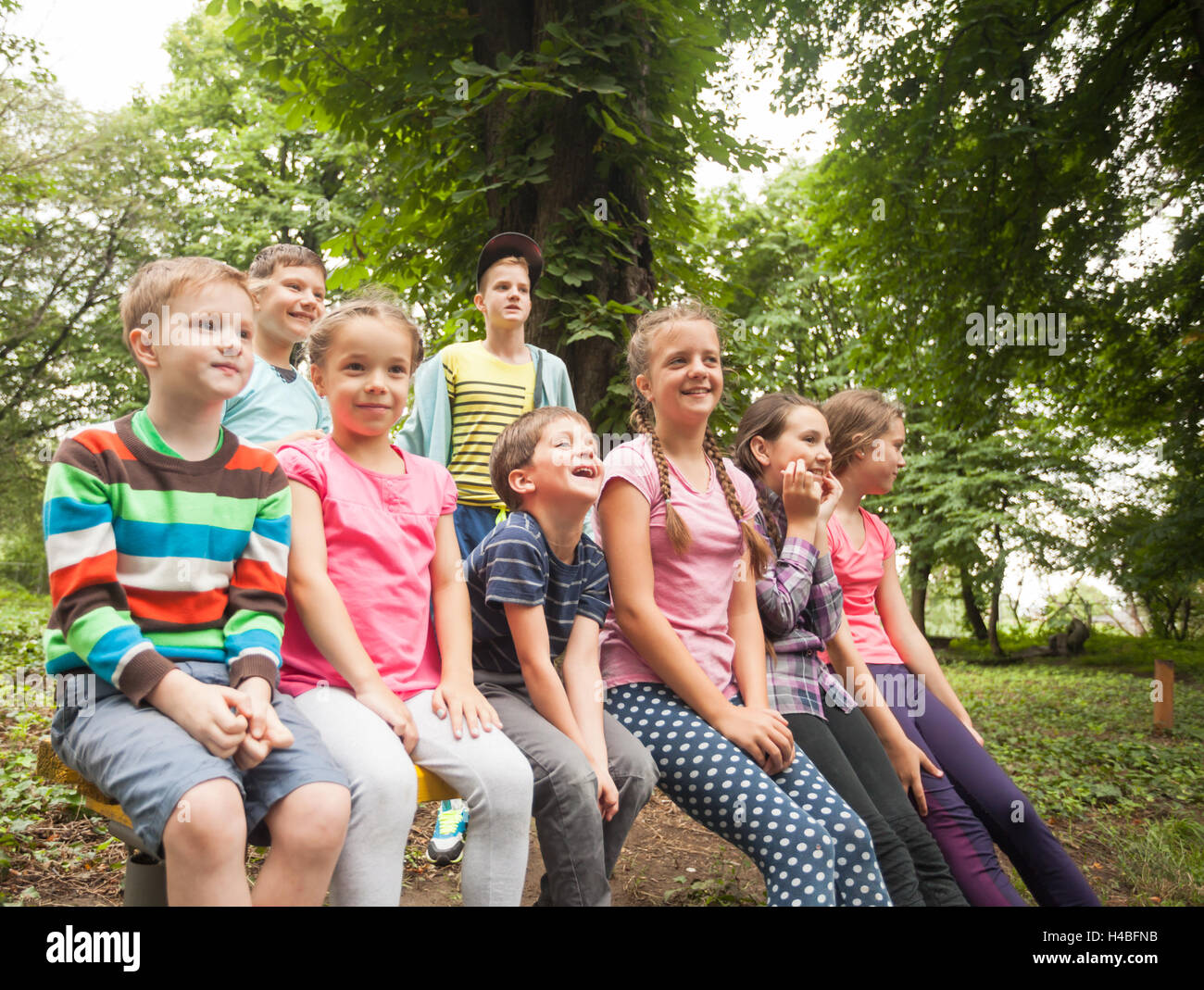 Group of children on a park bench Stock Photo - Alamy