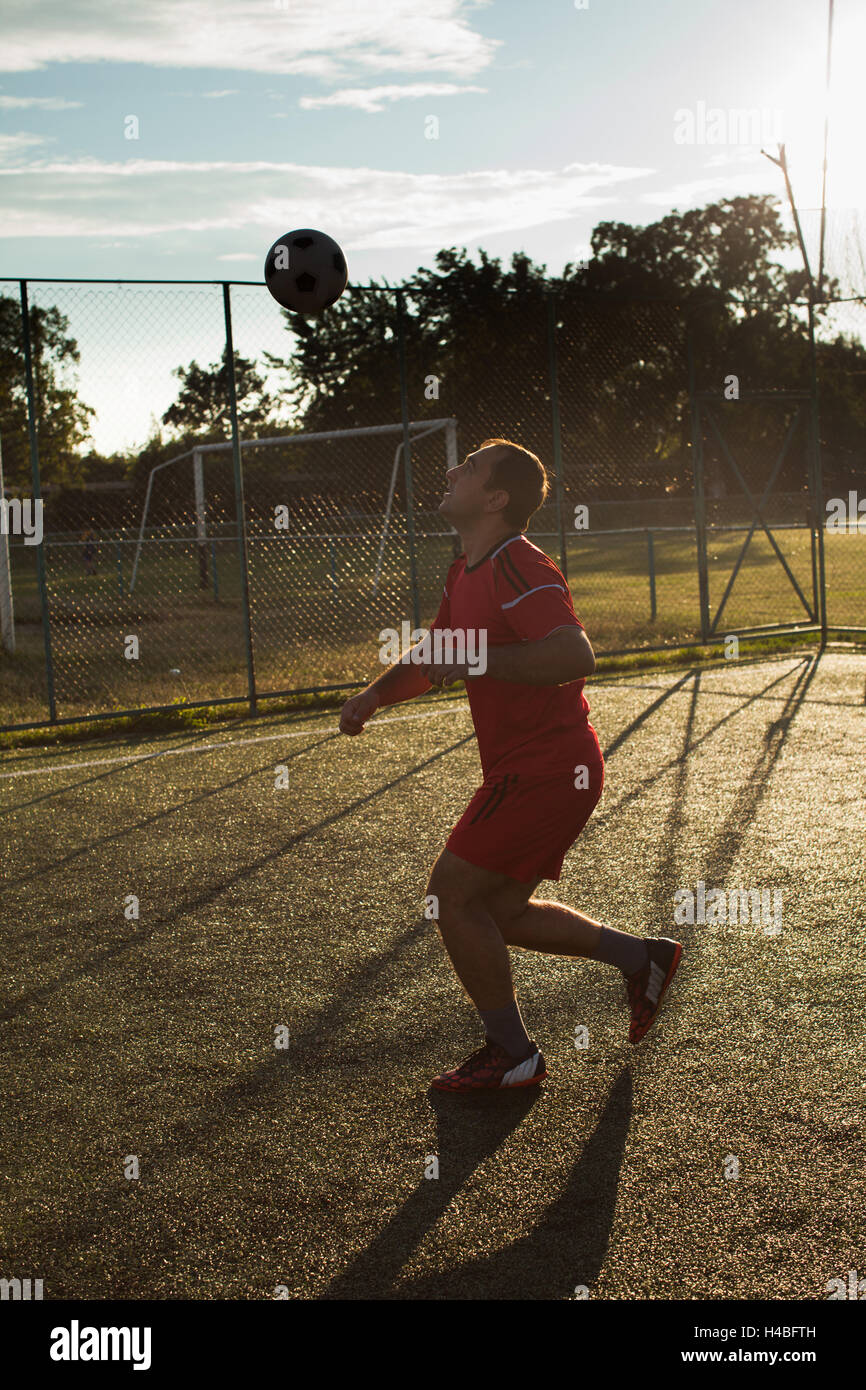 Soccer player in red Stock Photo - Alamy