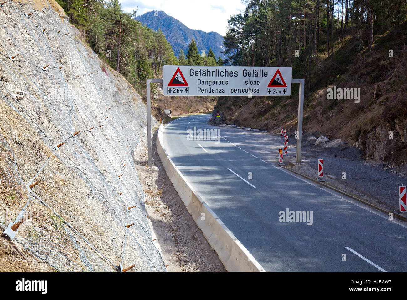 Warning sign at mountain road Stock Photo - Alamy