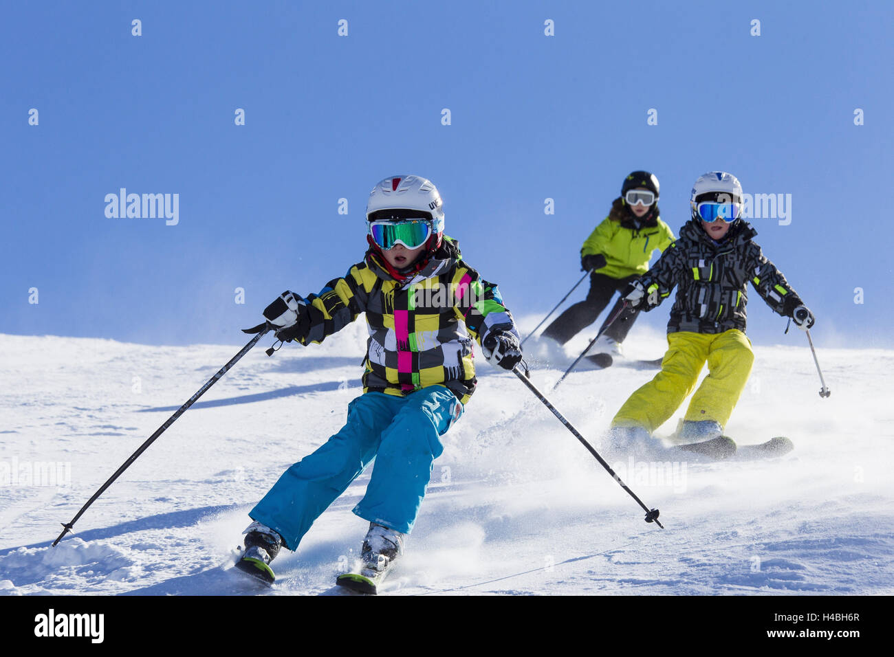 three children skiing one after the other on the slope Stock Photo - Alamy