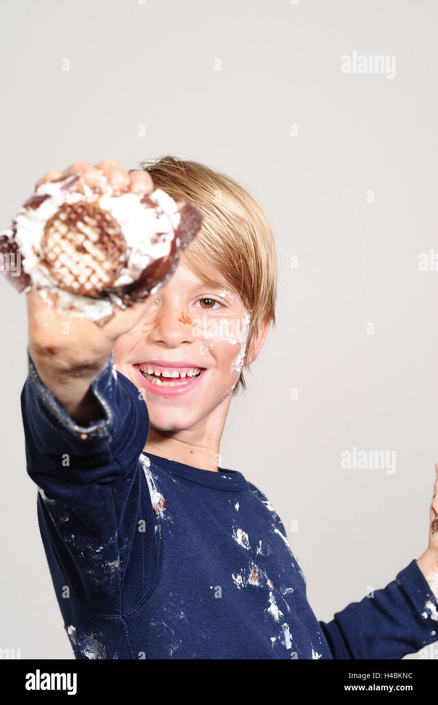 Boy with chocolate-coated marshmallow treat Stock Photo - Alamy