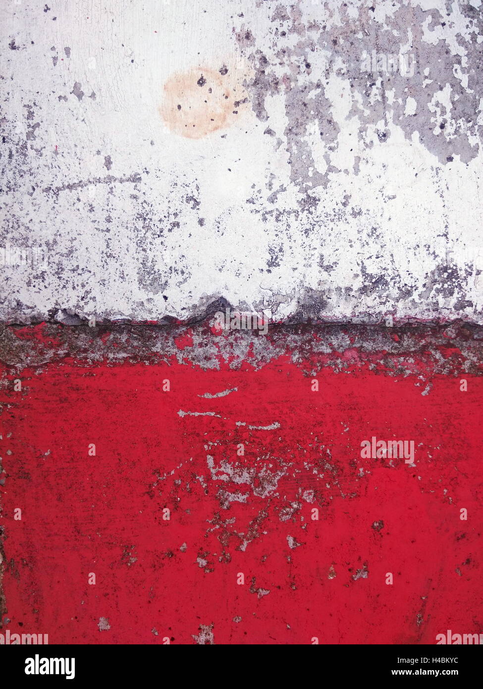 closeup shot of aged and decayed concrete surface in red and white ...