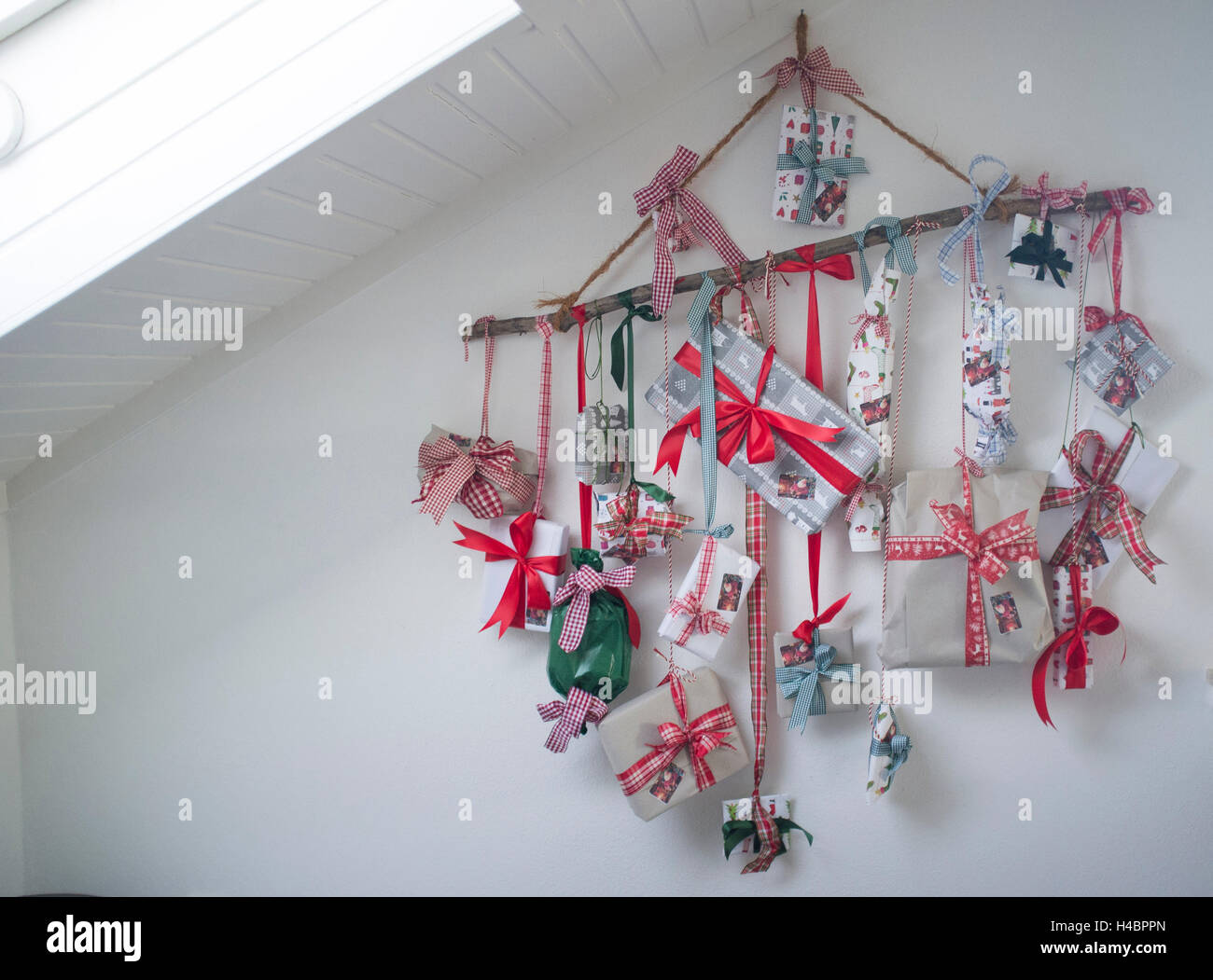 Advent calendar with packet in front of white wall Stock Photo - Alamy