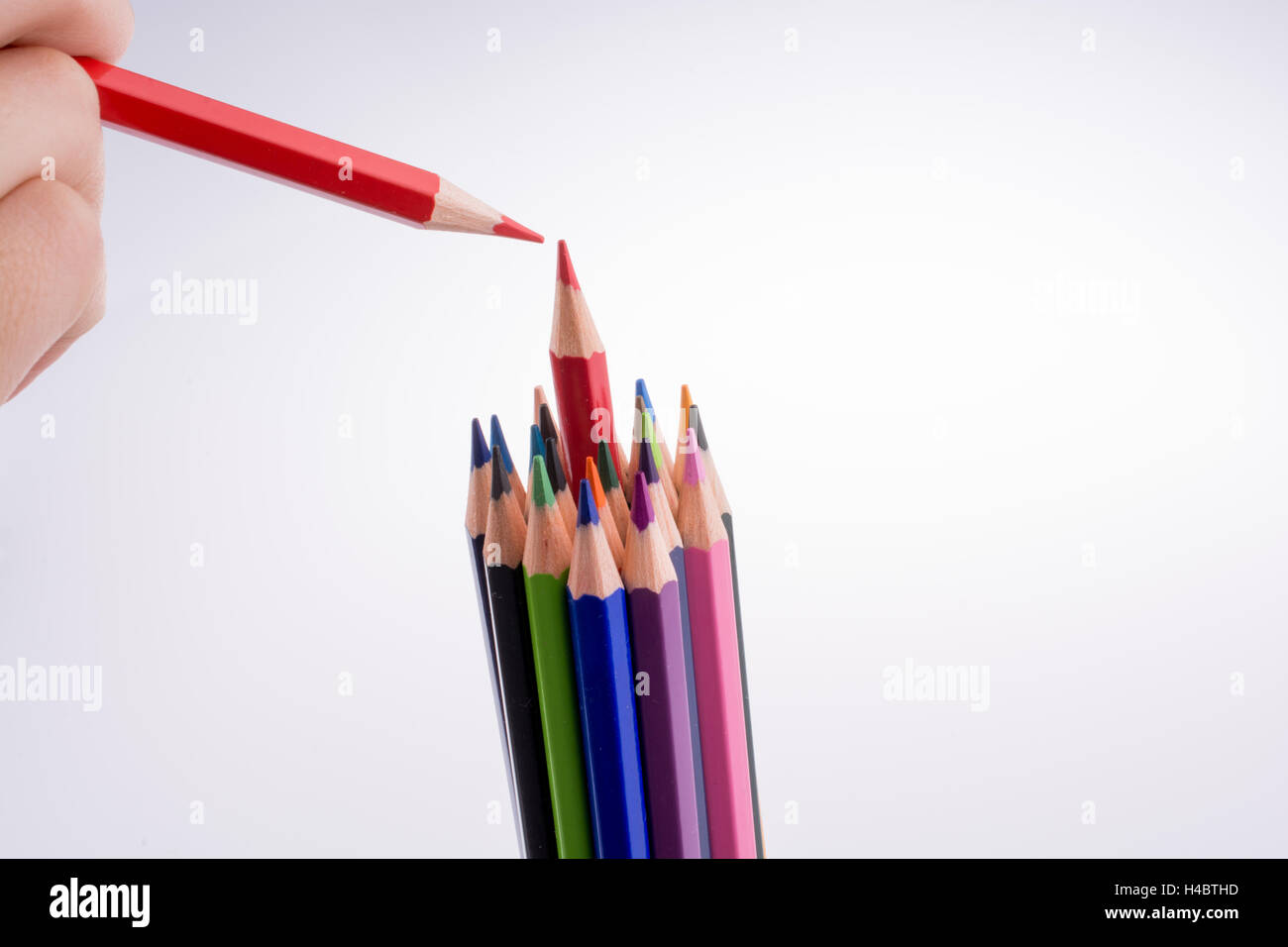 Hand holding color pencils on a white background Stock Photo - Alamy