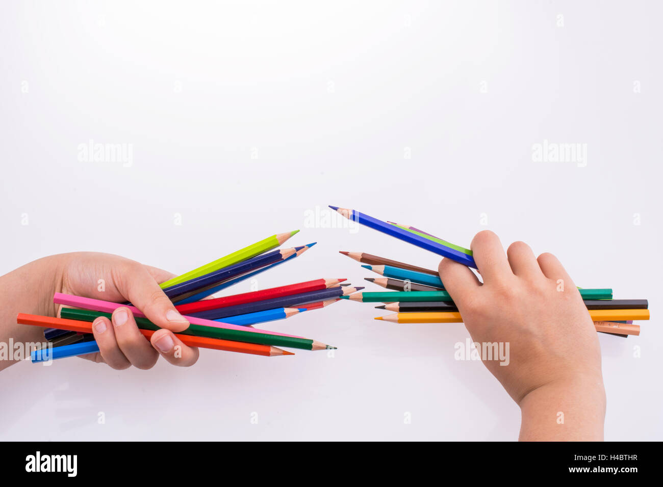 Hand holding color pencils on a white background Stock Photo - Alamy