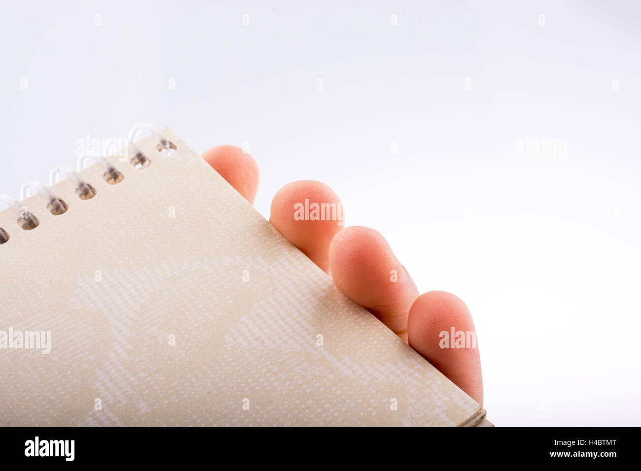 Hand holding Spiral blank notebook on a white background Stock Photo ...
