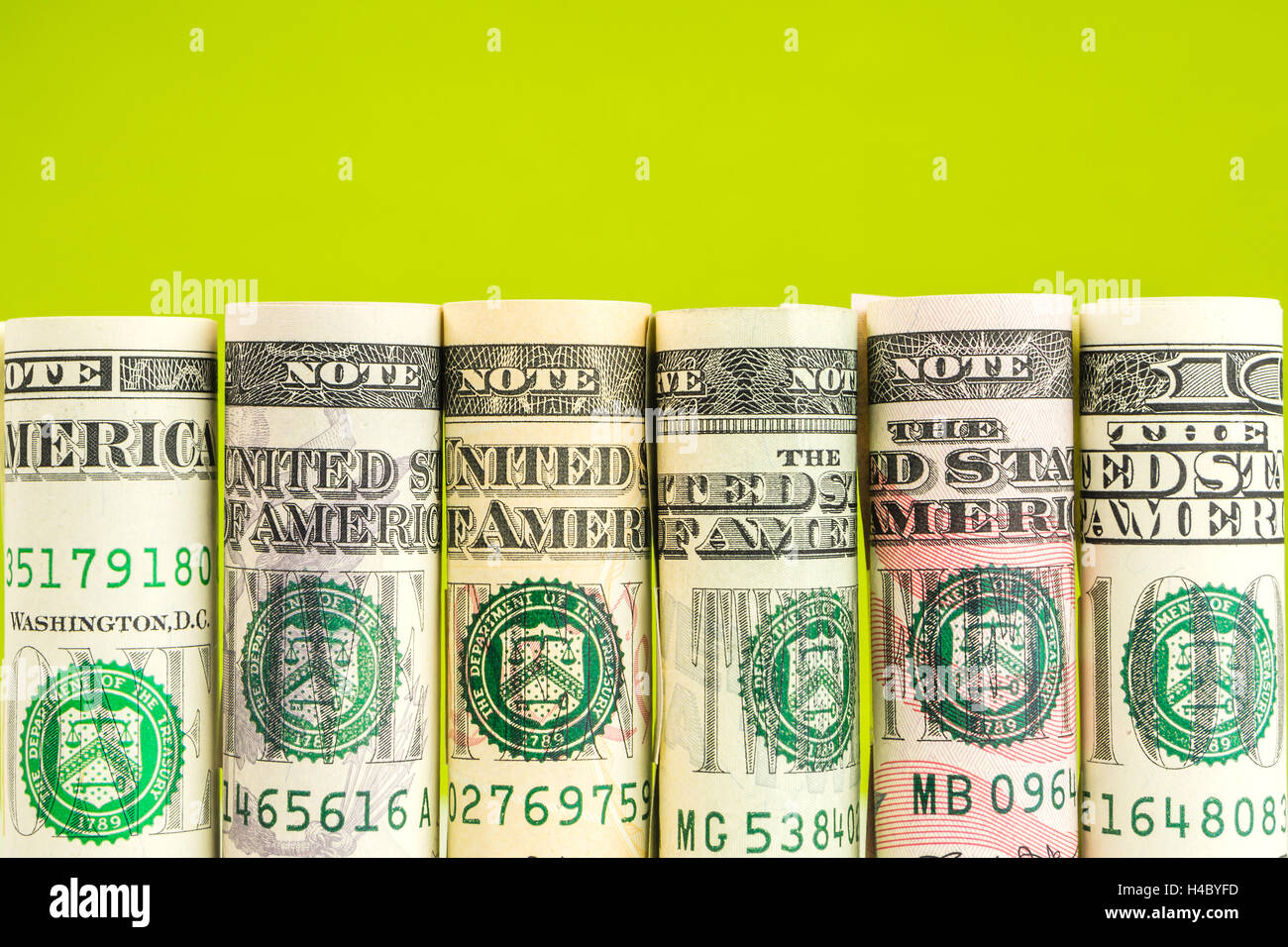 american dollar banknote rolls in all denominations in one row on green ...