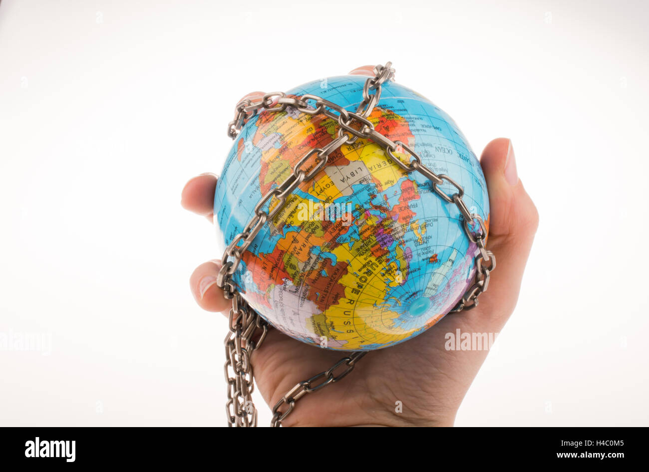 Globe in chain on a white background Stock Photo - Alamy
