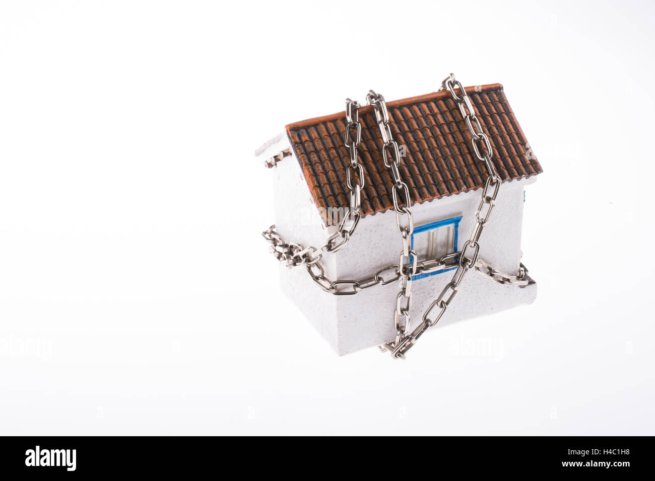 house in chains on a white background Stock Photo - Alamy