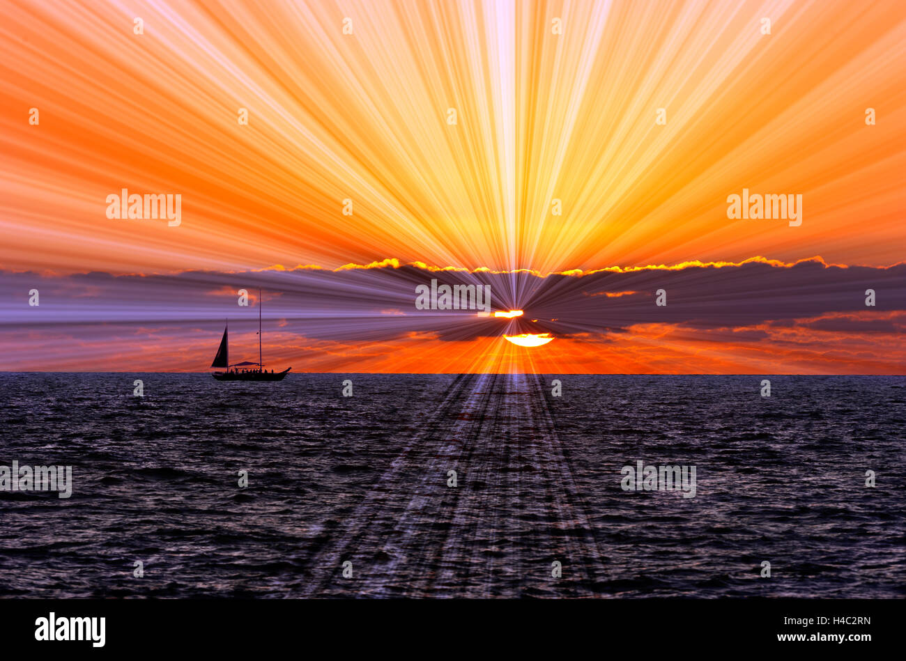 Sunset sailboat is a silhouetted boat sailing along the ocean water ...