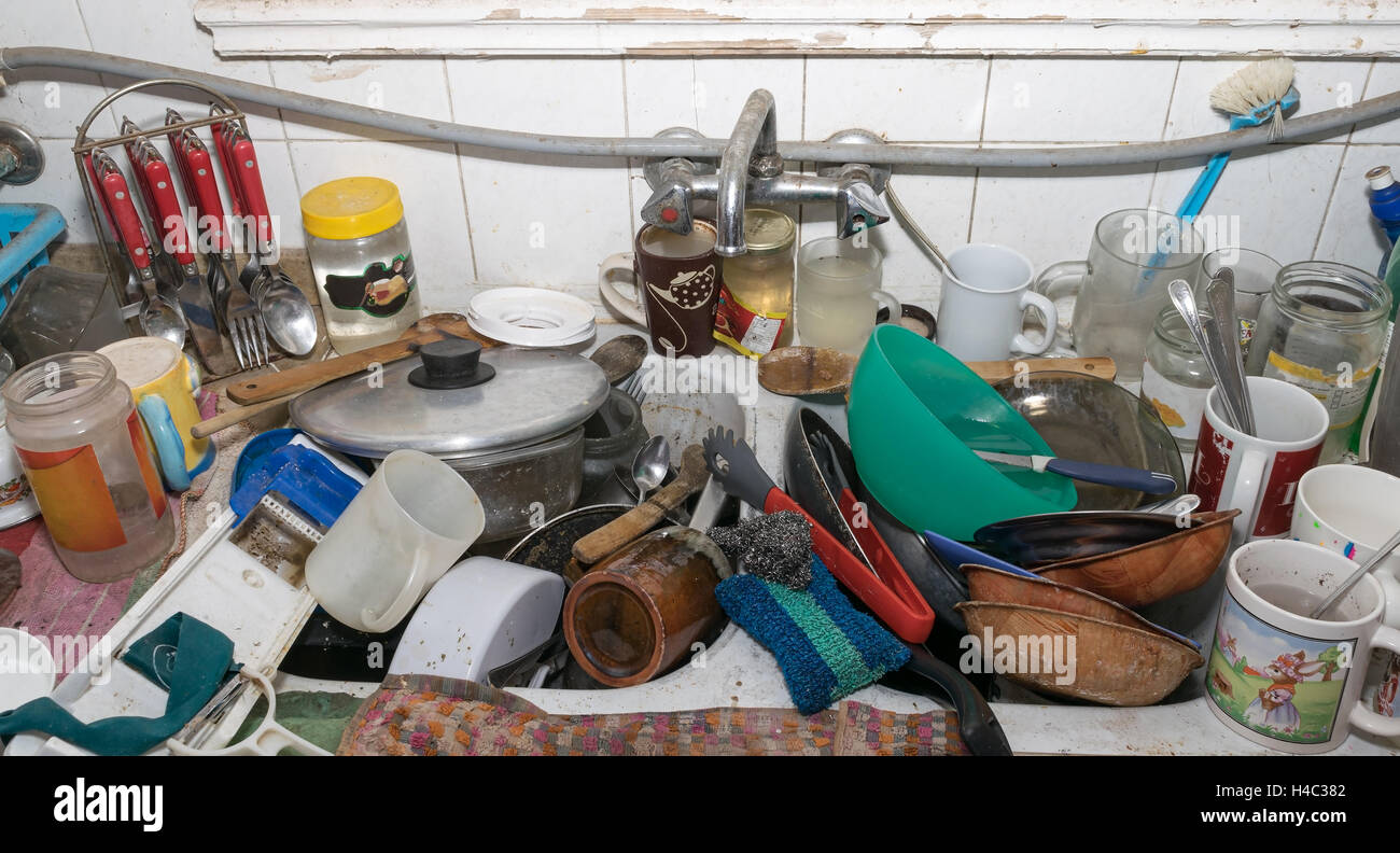 Pile of dirty utensils in a kitchen washbasin Stock Photo - Alamy
