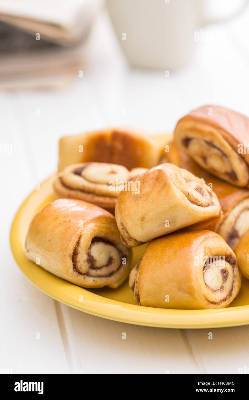 Mini cinnamon buns on white kitchen table Stock Photo - Alamy