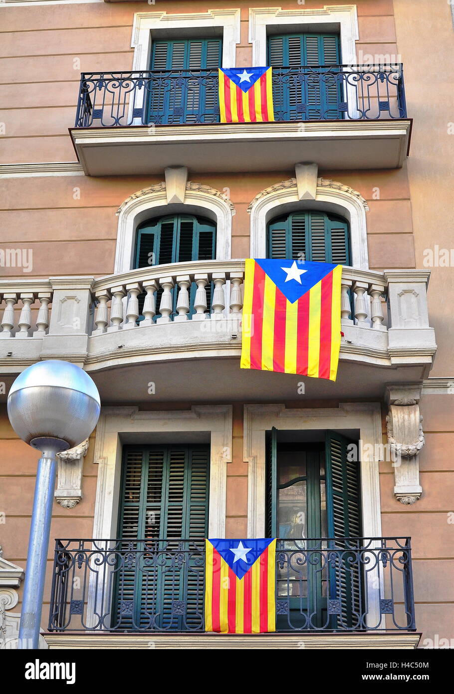 Houses of Barcelona city with flags of Catalonia Stock Photo - Alamy