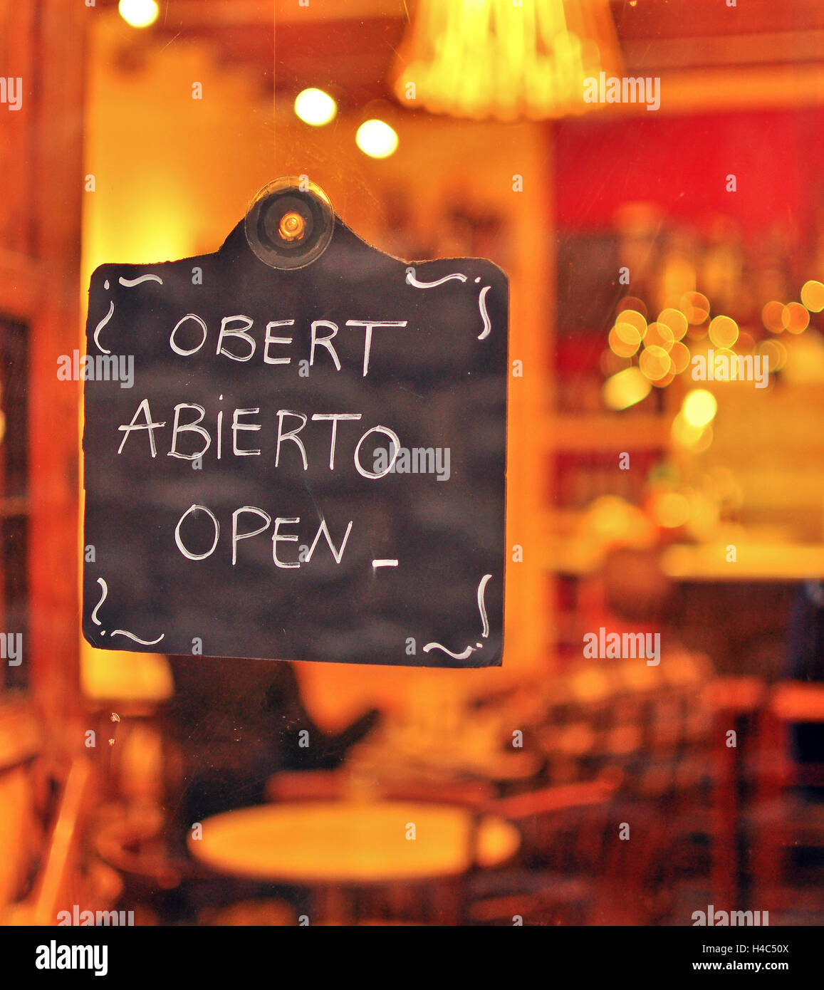 Open sign in english, catalan and spanish languages Stock Photo - Alamy