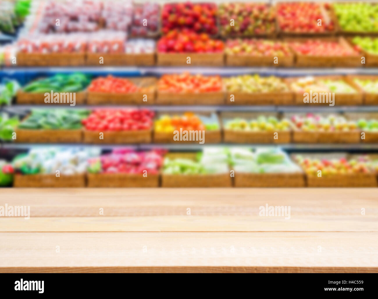 Wooden empty table in front of blurred supermarket fruits shelf Stock ...