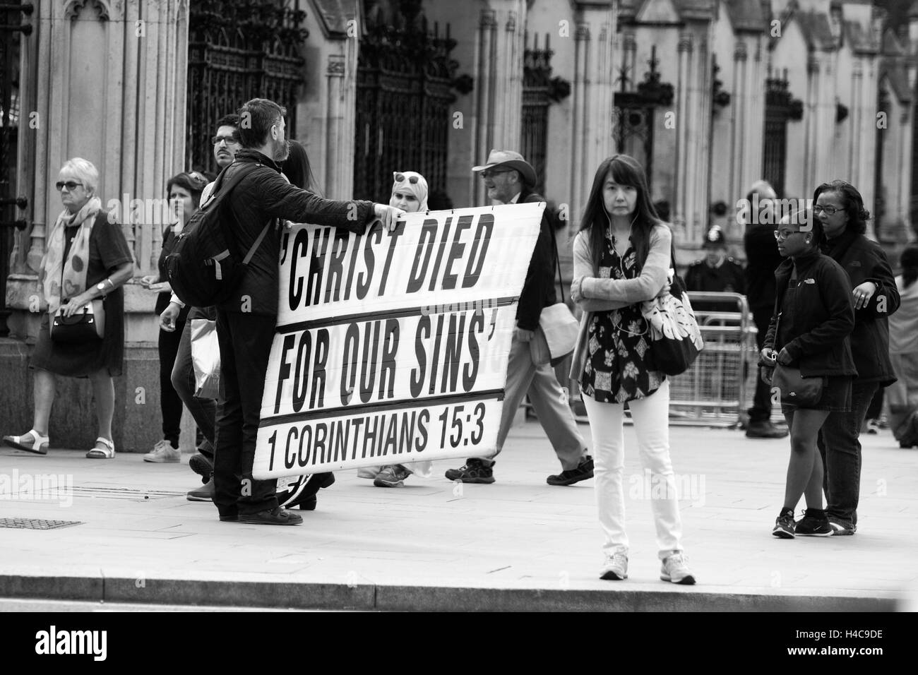 A street preacher preaching to people walking passed The Houses of ...