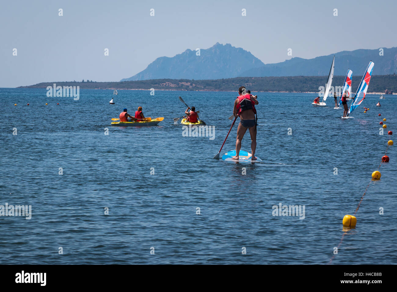 Stand up Surfer Man Paddleboarding on Board among Canoes and Windsurf ...