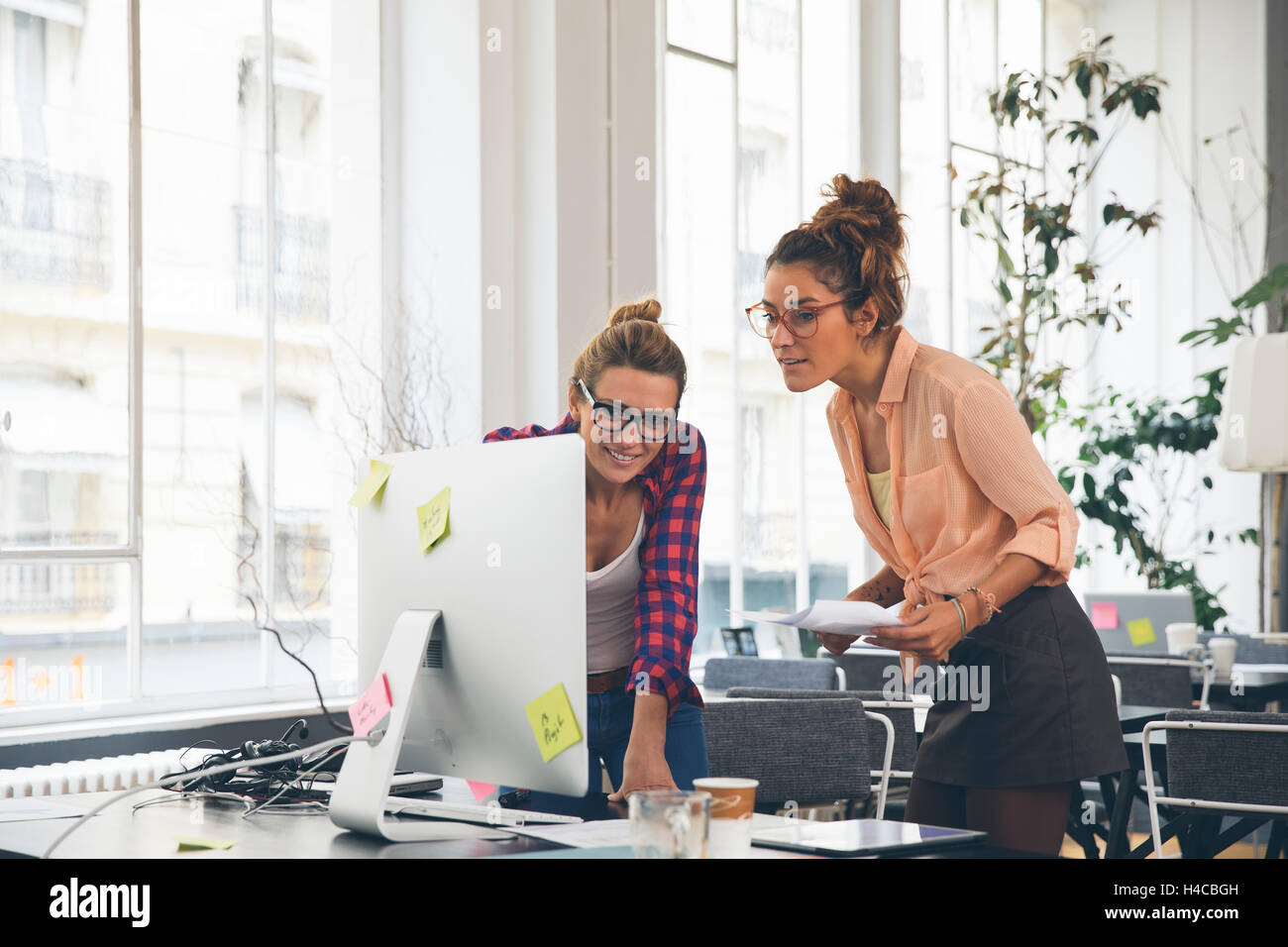 Two women working together in office Stock Photo - Alamy