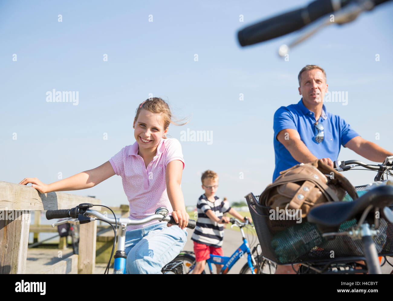 Family drives bicycle by the sea Stock Photo - Alamy