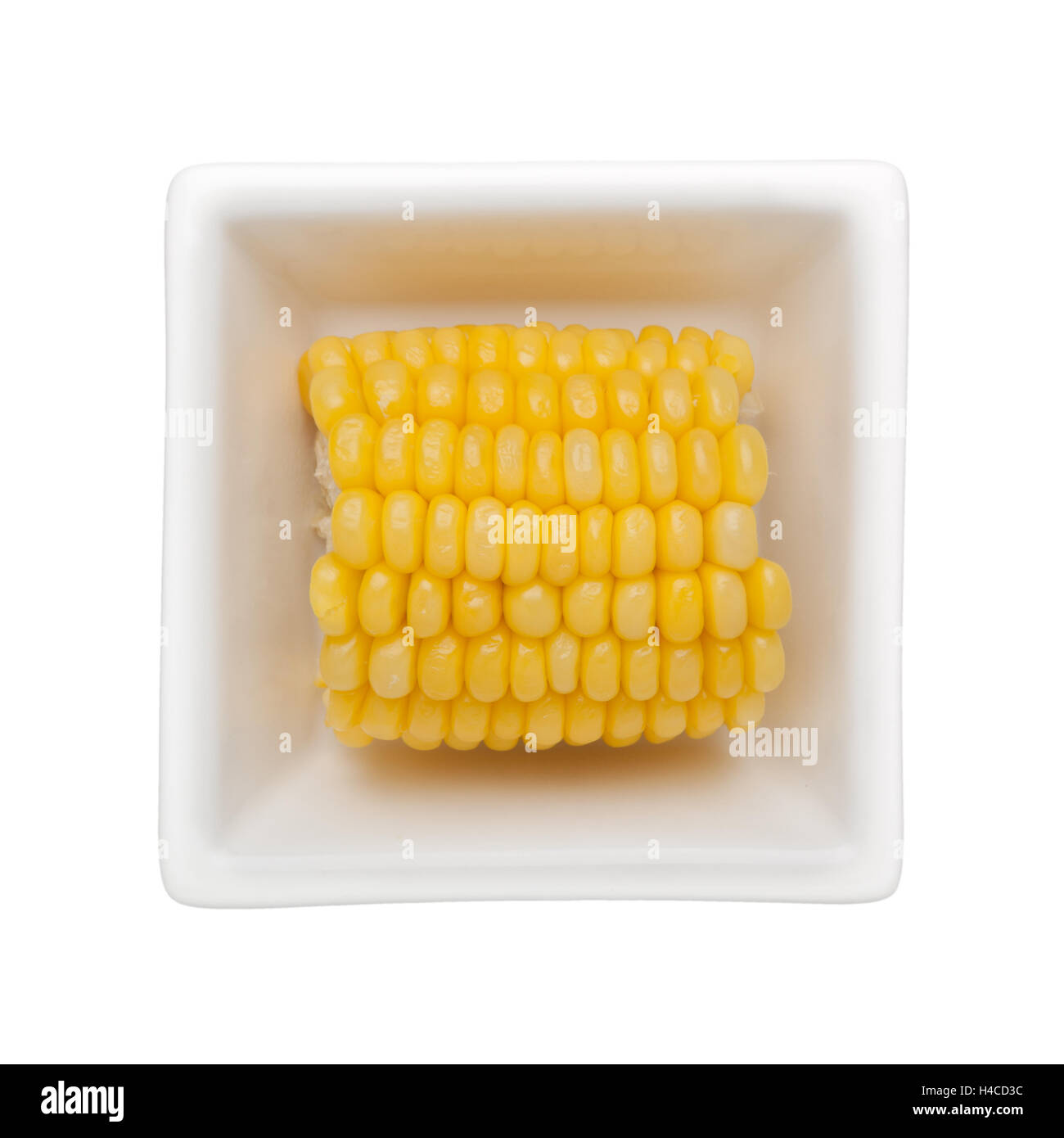 Corn cob in a square bowl isolated on white background Stock Photo - Alamy