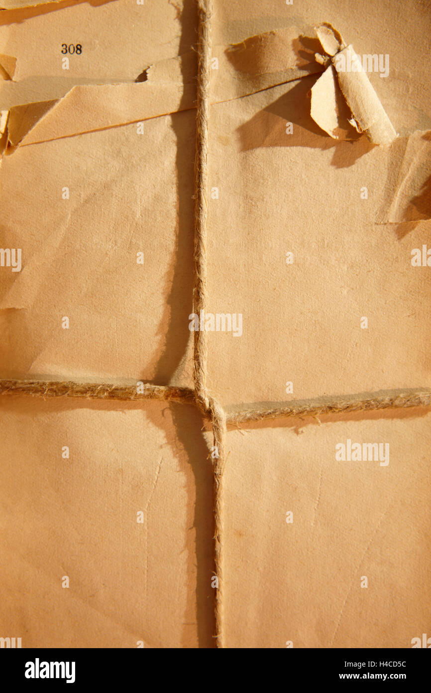 Antique broken packaging wrapped with a string in warm tone. Vertical ...