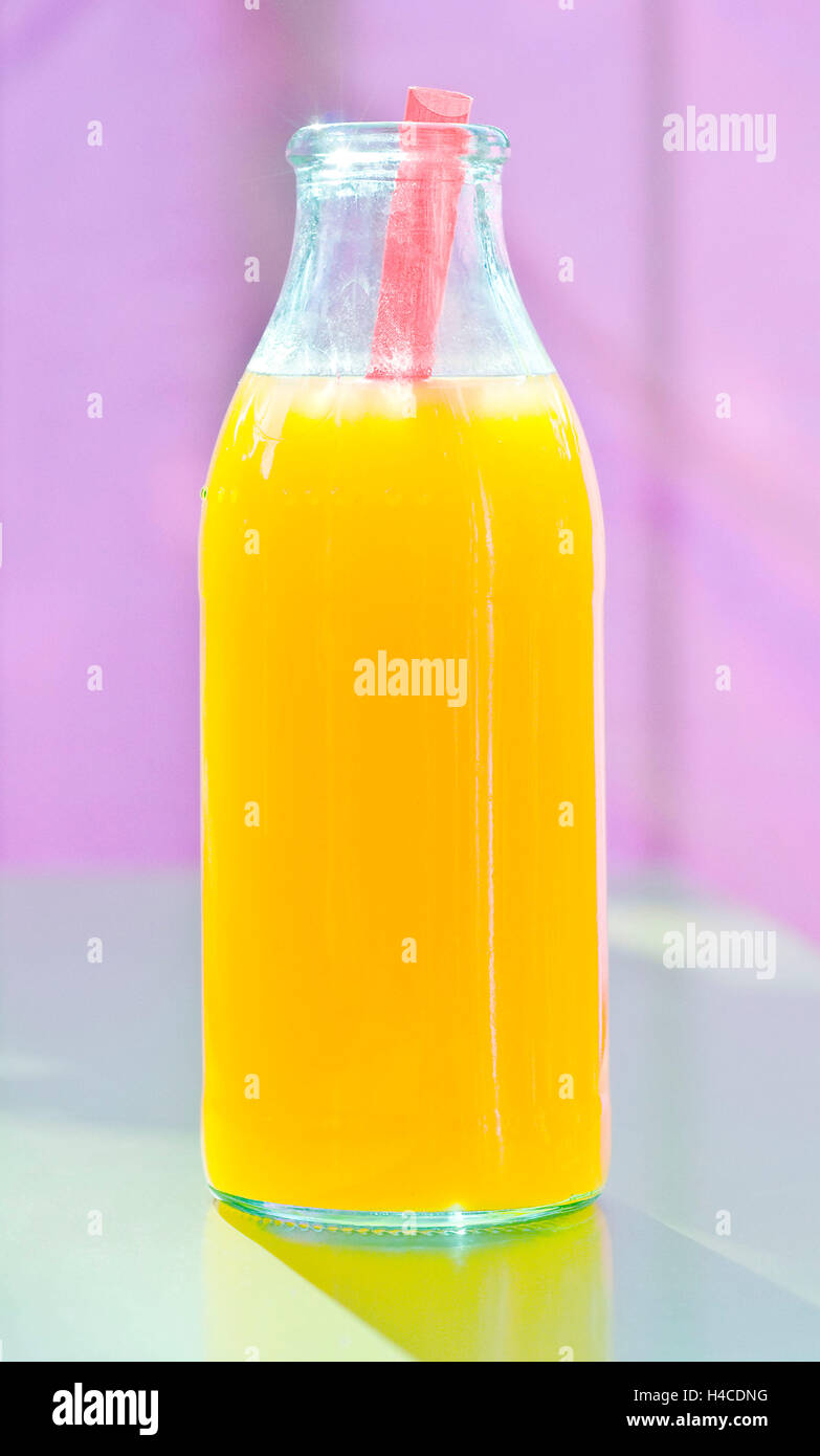 Glass bottles with mango juice Stock Photo - Alamy
