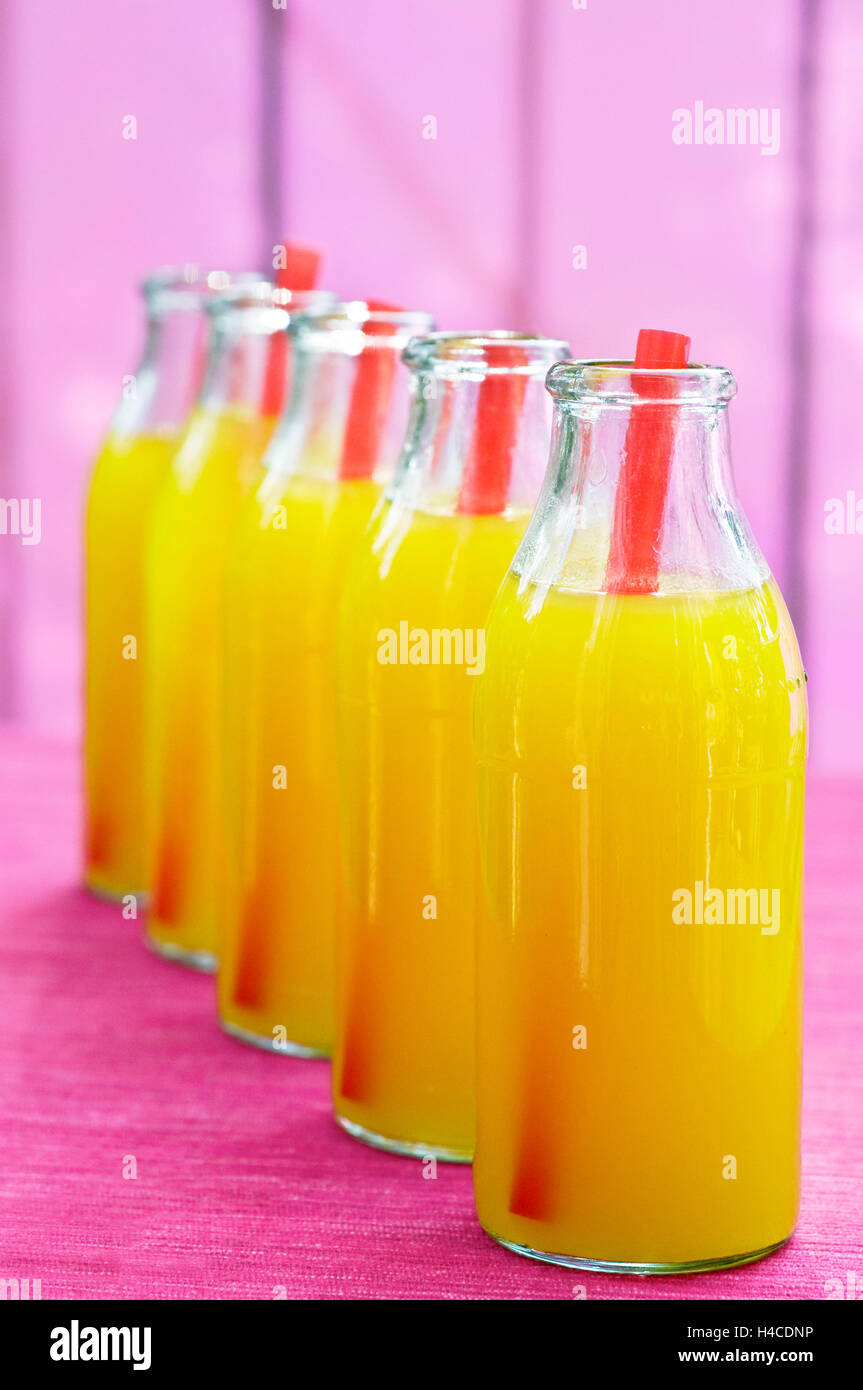 Glass bottles with mango juice Stock Photo - Alamy