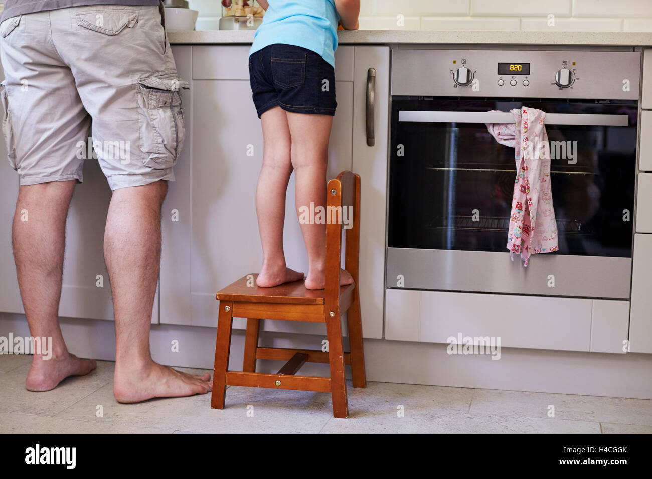 Girl standing on chair reaching hi-res stock photography and images - Alamy