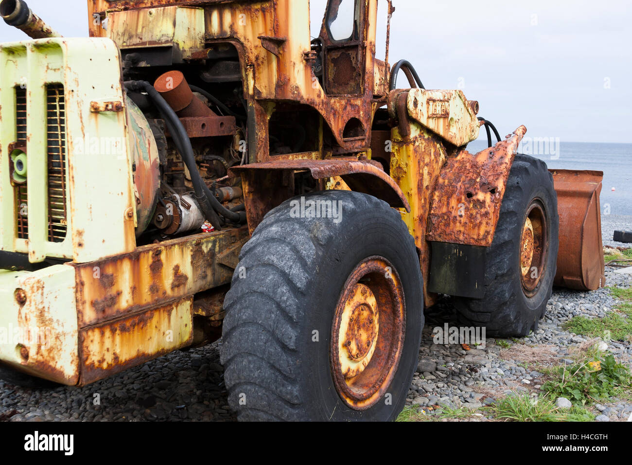 Rusty digger on beach Stock Photo - Alamy